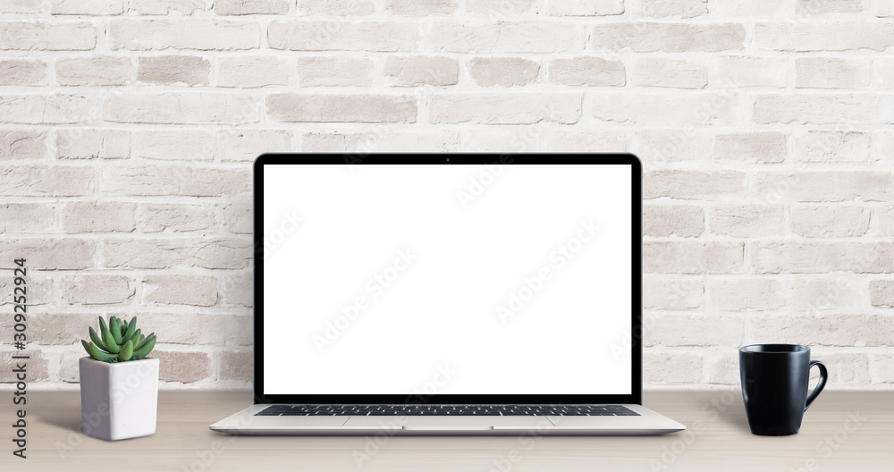 Laptop mockup on simple, clean desk with brick wall in background ...