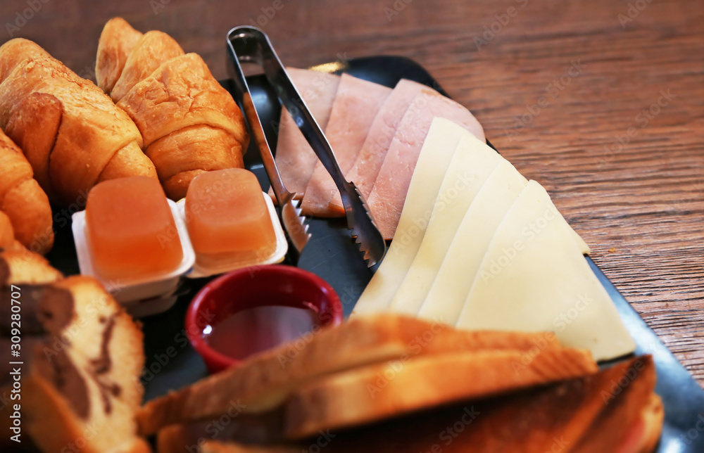 breakfast brunch plate with cold cuts, croissant, cake and marmalade ...