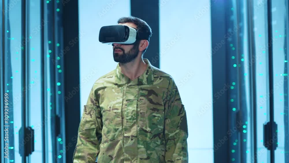 Soldier in army uniform wearing a VR headset experiencing augmented ...