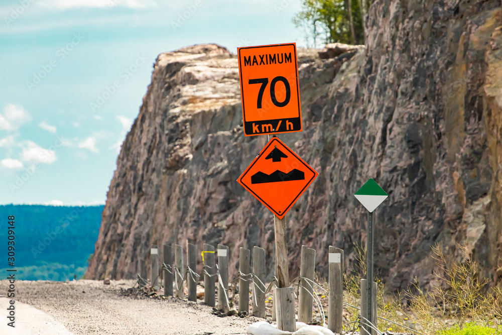 Temporary condition road signs, an orange sign shows the maximum safe ...
