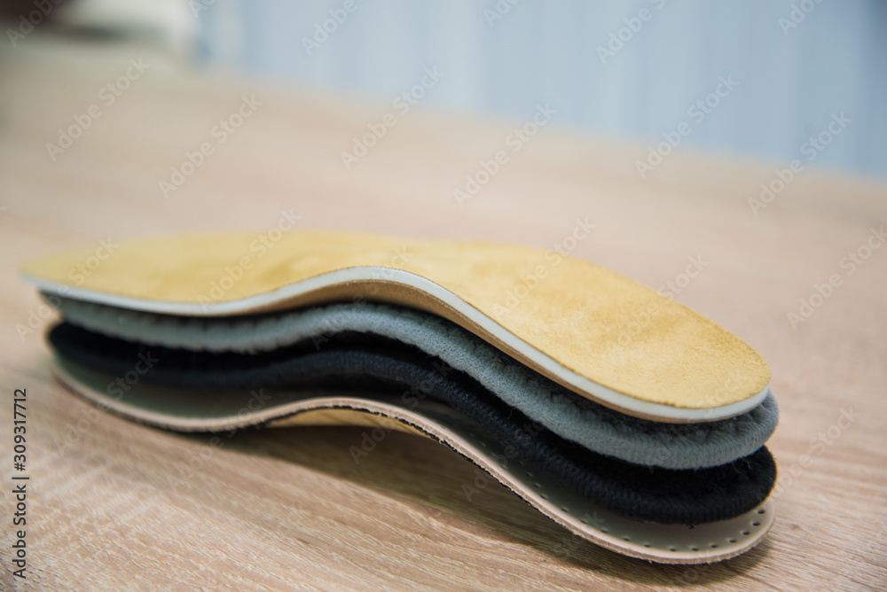 samples of different orthopedic insoles. insole with a variety of ...