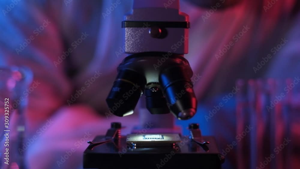 researcher in scientific and technical laboratory with neon light ...