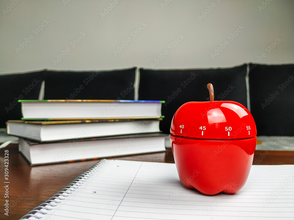 Pomodoro study technique with apple shaped kitchen timer standing on a ...