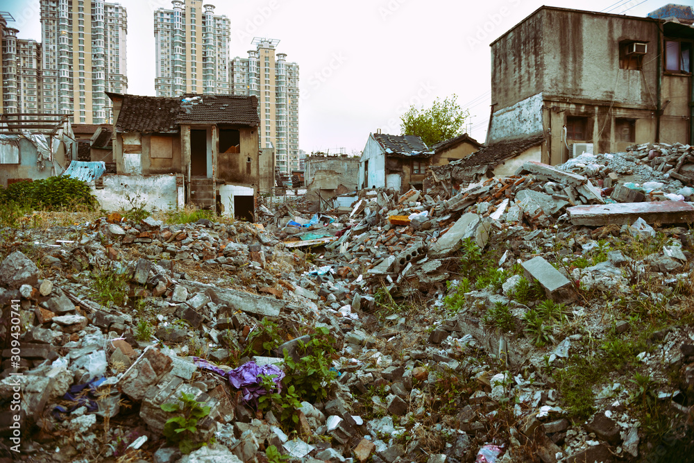 Old ruin house with people still living in, modern buildings in ...