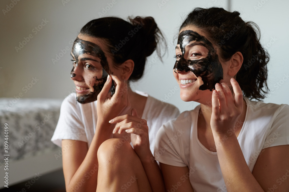 Laughing girls removing face masks Stock Photo | Adobe Stock
