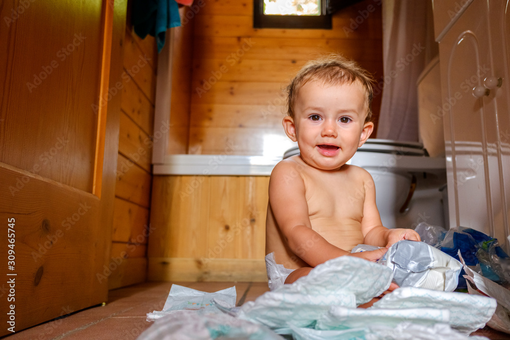 Baby on the floor of the bathroom making a mess with his diapers, fun ...