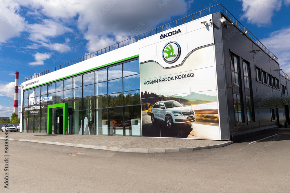 Skoda dealership with a modern facade and cars on display in front of ...