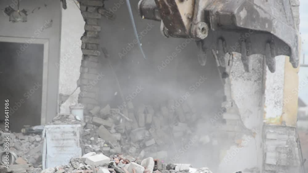 Remains of a damaged building after an earthquake in Thumanë. Excavator ...