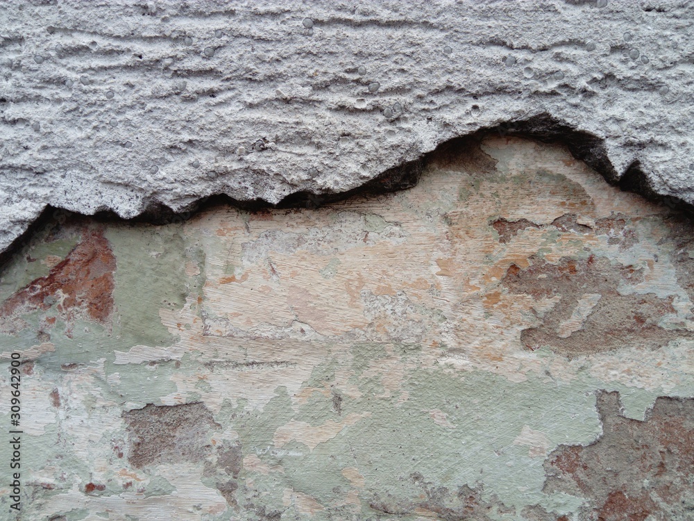Crack on the wall of the house. Poor quality stucco falls off the ...