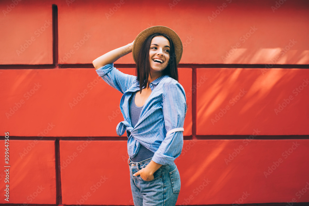 Cheerful Ukrainian woman laughing near brick wall enjoying free time ...