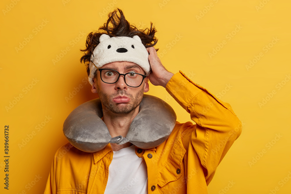 Tired Caucasian man has dissatisfied gloomy expression, travels by ...