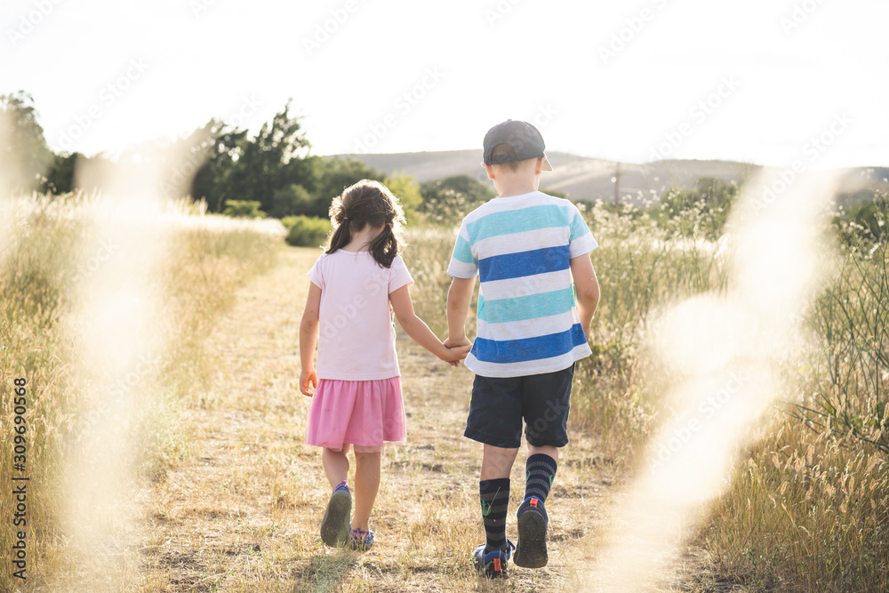 Kids playing in dry grass Stock Photo | Adobe Stock
