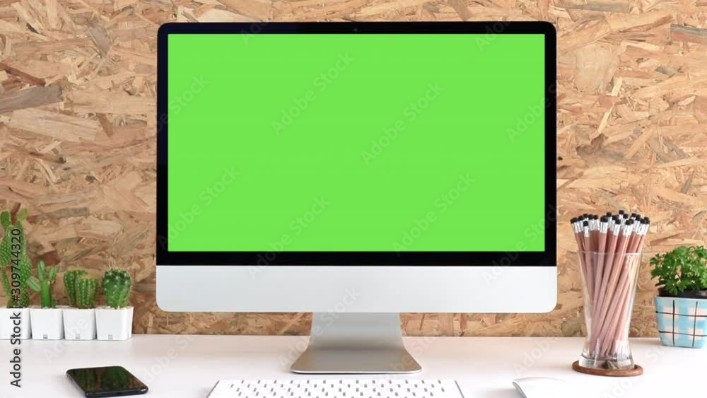 Computer desktop with mock-up green screen white background in office ...