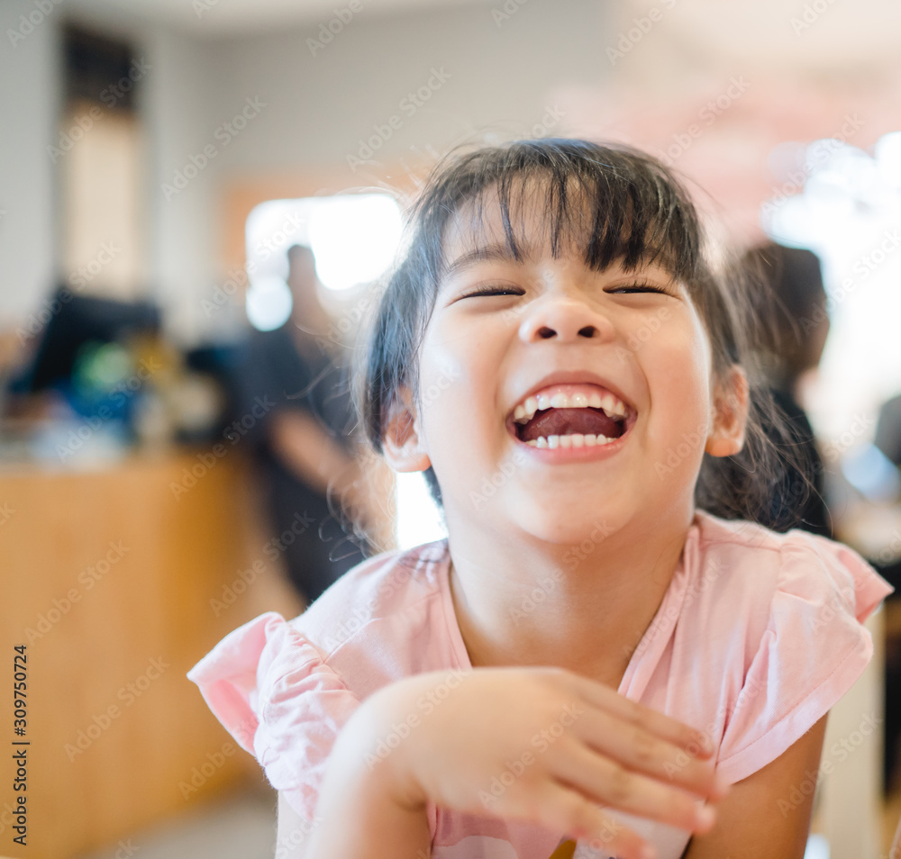Happy Little asian girl child showing front teeth with big smile and ...