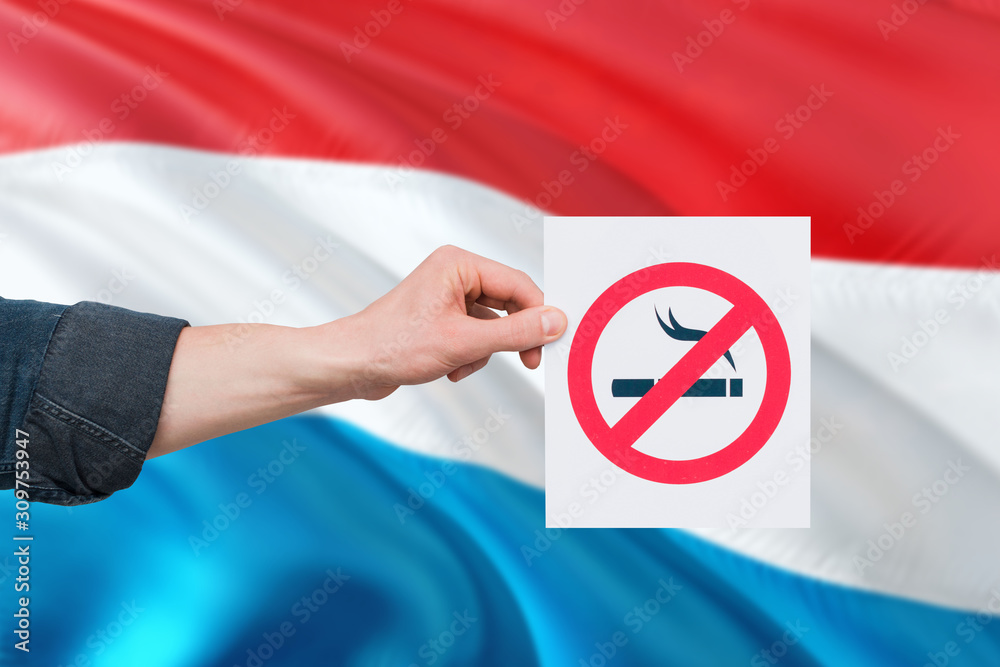Luxembourg health concept. Hand holding paper with no smoking sign over ...