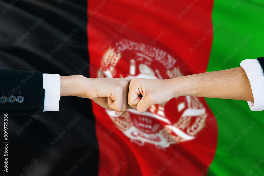 Afghanistan agreement concept. Man and woman fist bumping on national ...