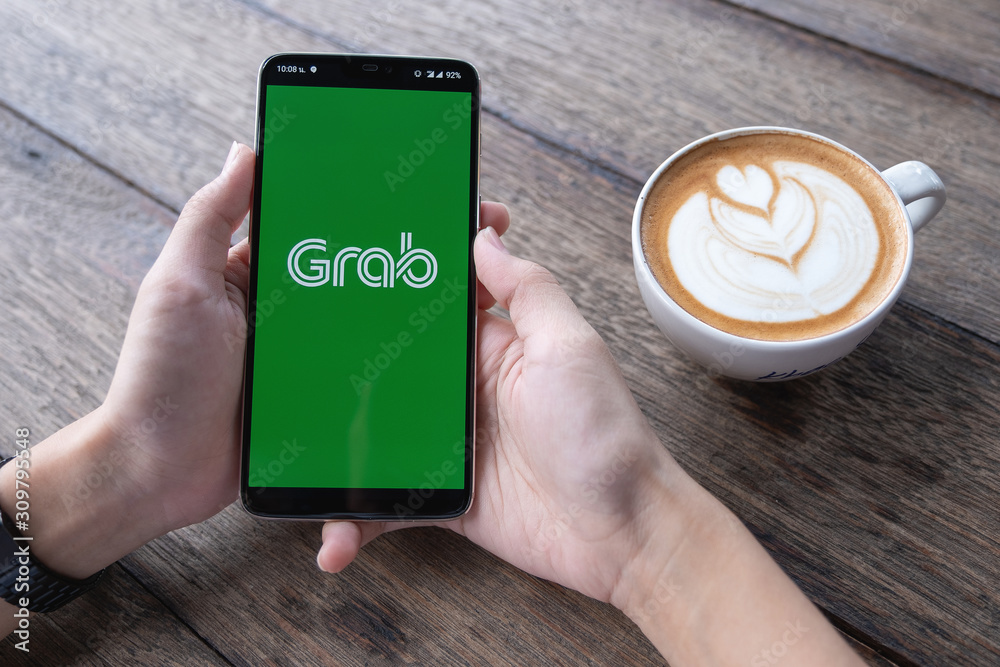 CHIANG MAI,THAILAND - May 11, 2019 : A MAN hand holding Grab app ...