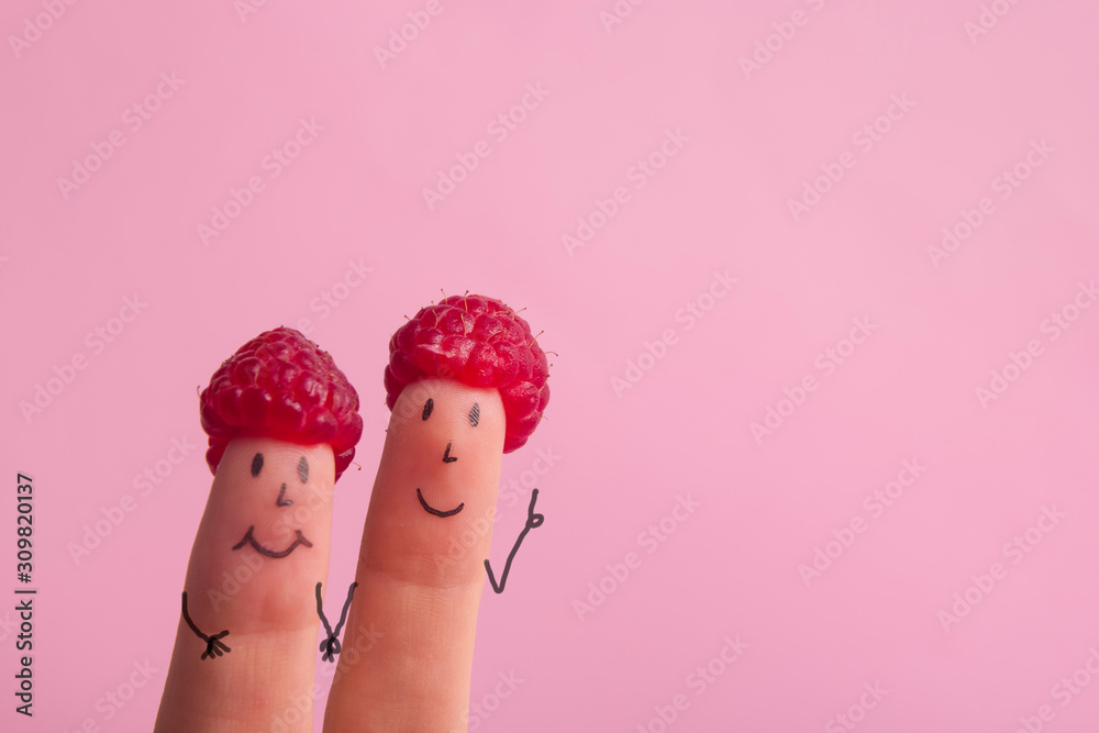 Funny fingers faces in hat raspberries berry against pink background ...