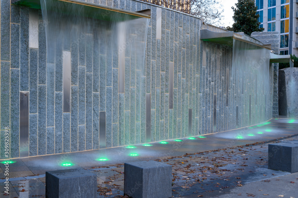 The water feature is glowing in the early even. The water fountain is ...