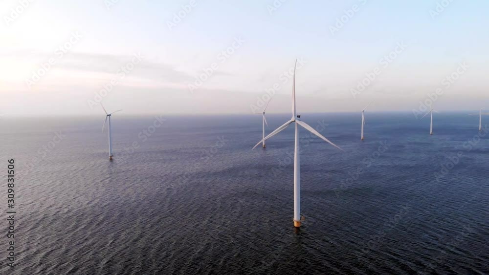 aerial view at windmill park during sunset in the Netherlands, green ...