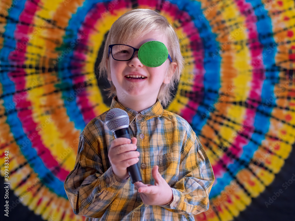 Portrait of funny child in new glasses with green spot to correct ...