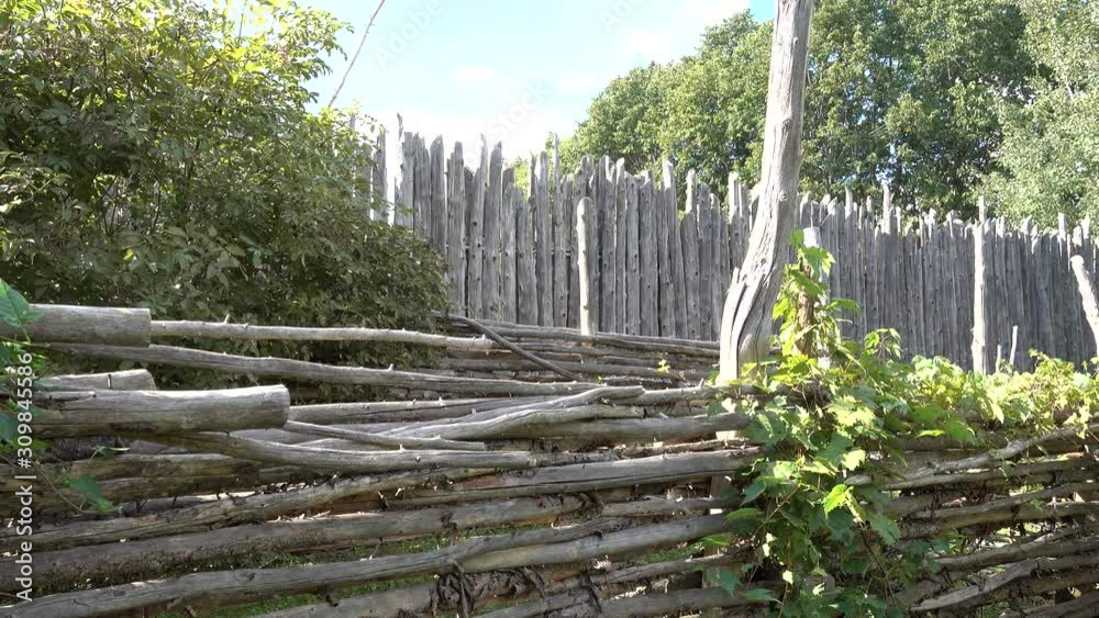 Zoomed Out Left To Right Pan Of Wooden Fort With Spikes Logs Of Native ...