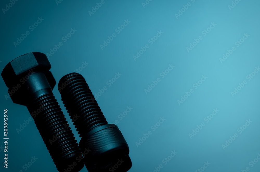 Metal bolts on blue background. Hardware tools. Closeup hex head bolt ...