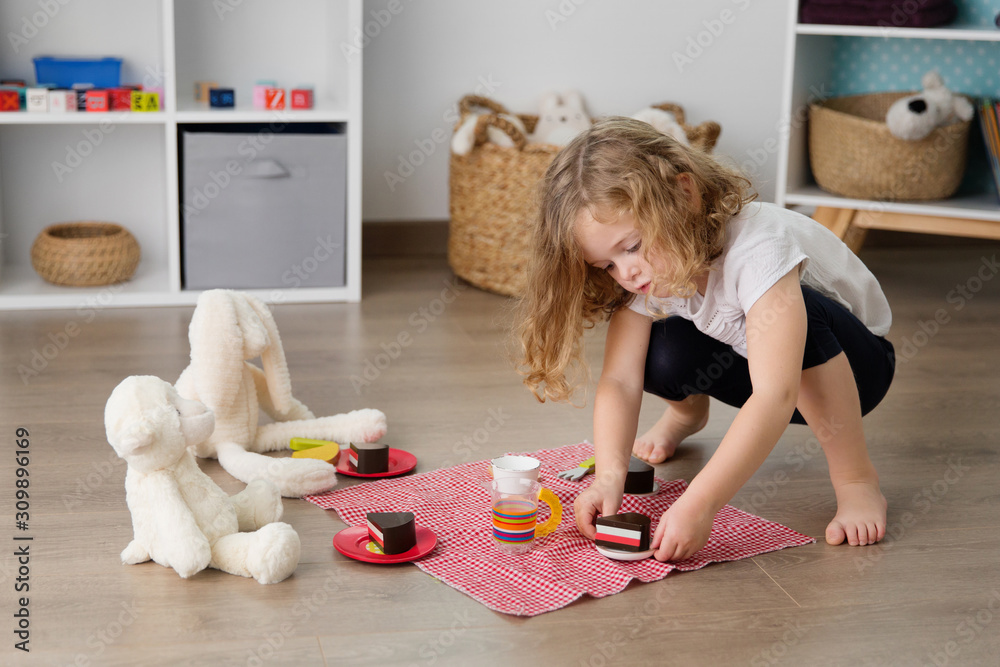 Little girl having tea party with stuffed toys at home Stock Photo ...