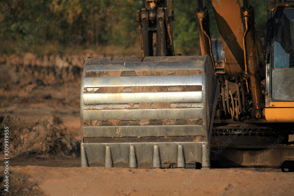 Excavator (digger) with a huge bucket at a construction site ...