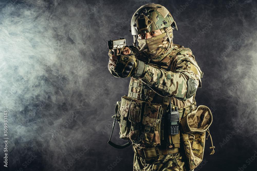fearless brave strong man with gun isolated in black foggy space, in ...