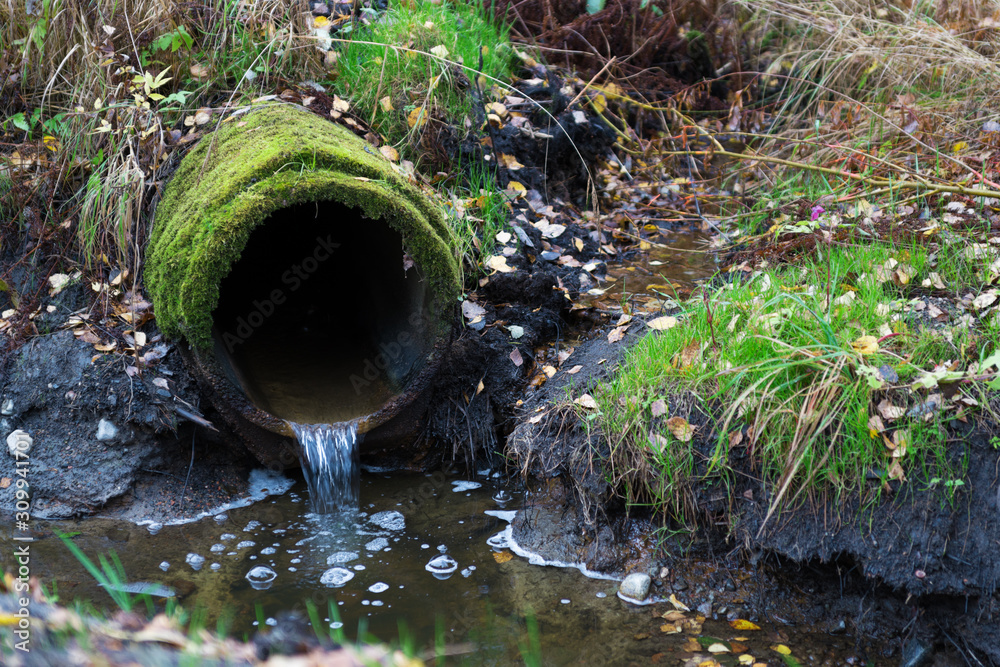 rainwater drainage drains into muddy ditch Stock Photo | Adobe Stock