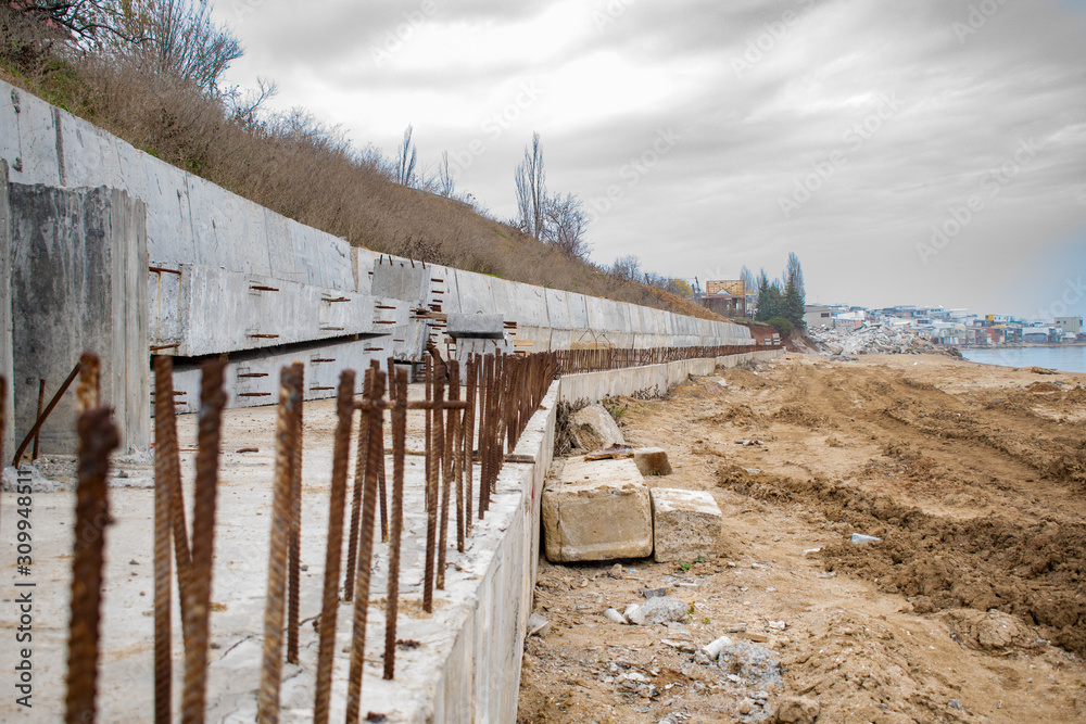 Seawall construction in progress. Enforcing shoreline with reinforced ...