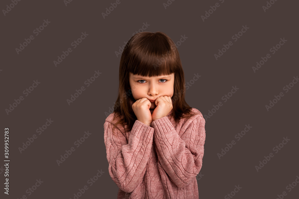 Offended scared depressed little girl child folded arms near face with ...