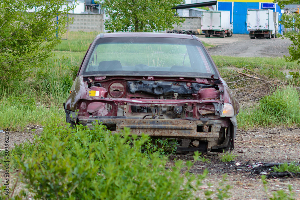 Broken, crumpled, dented car after the accident. Abandoned wrecked cars ...