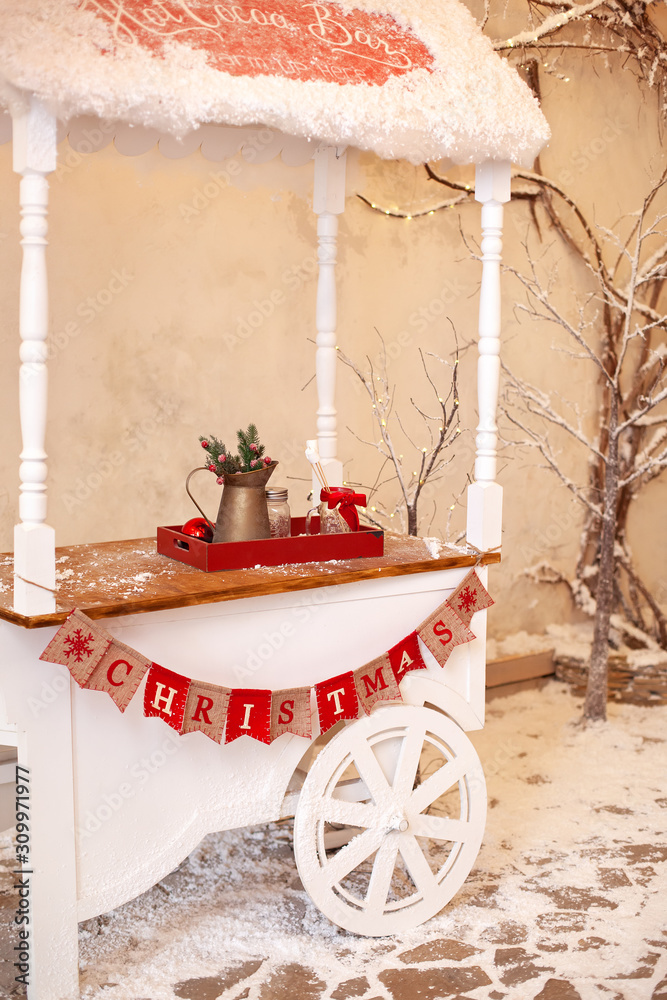 Decorative white wooden cart in garden and candy bar in winter. Street ...
