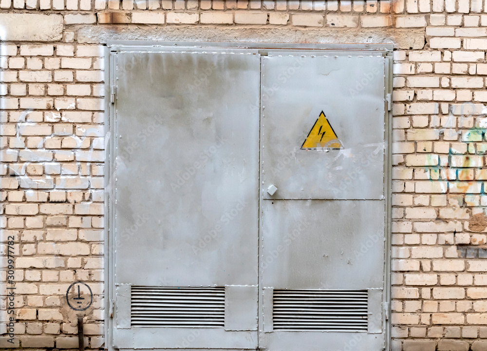 Texture of a gray metal door to an old transformer substation with a ...