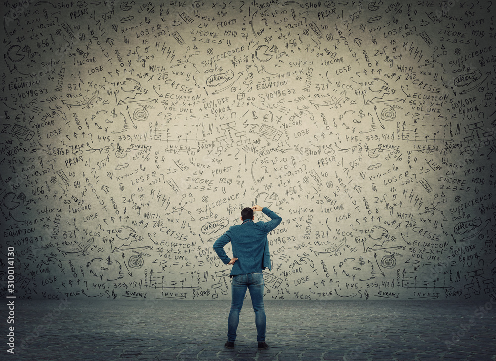 Rear view of puzzled businessman, hand to head thoughtful gesture ...