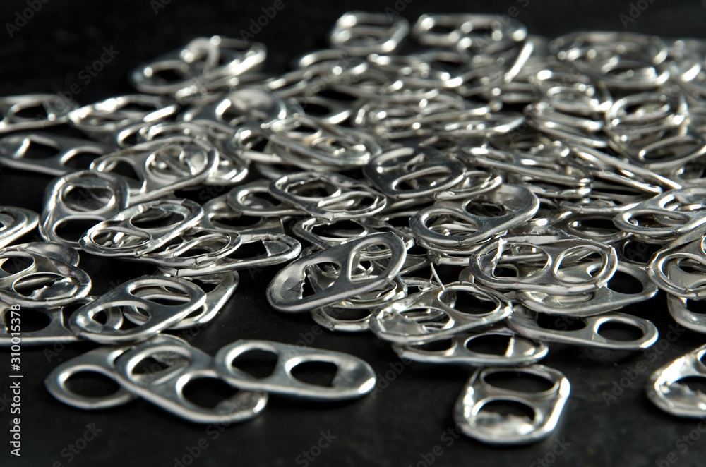 Recycling Beer and Pop Can Aluminum Tabs on Black Background Stock ...