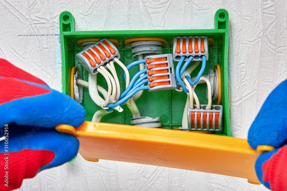 Splicing electrical wires with a clamp terminal. Stock Photo | Adobe Stock