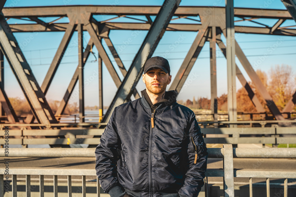 Poster portrait of young rapper posing under a metal bridge – Wall Art ...