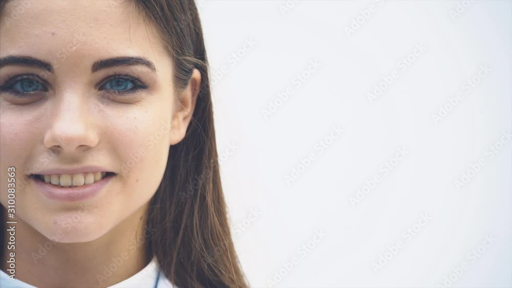 Cropped face of lovely young woman wearing white medical coat and ...