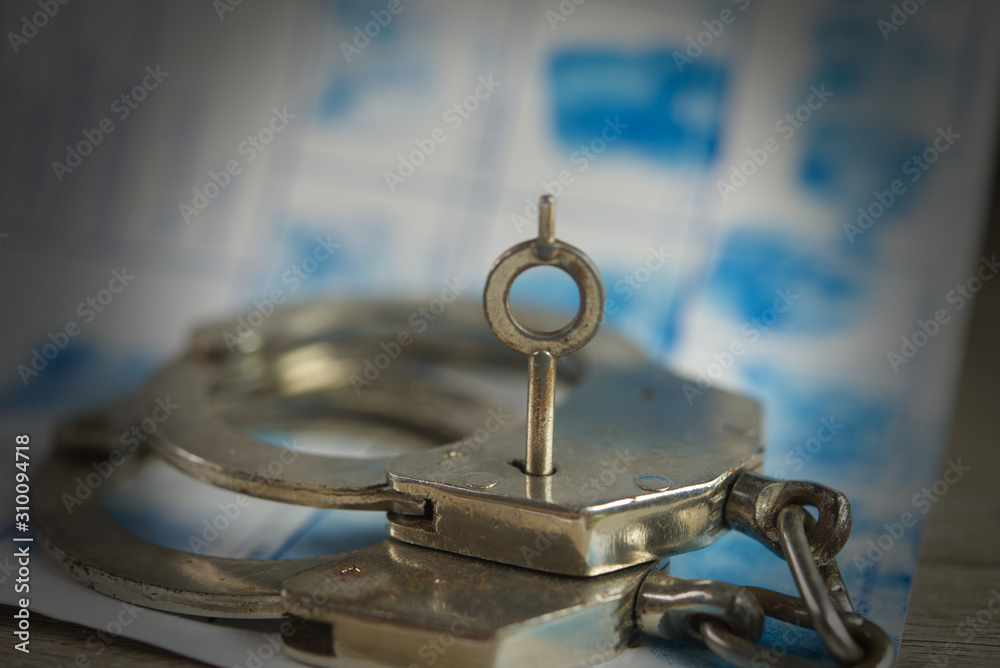 Crime and violence concept.Police Handcuffs on fingerprints crime page ...