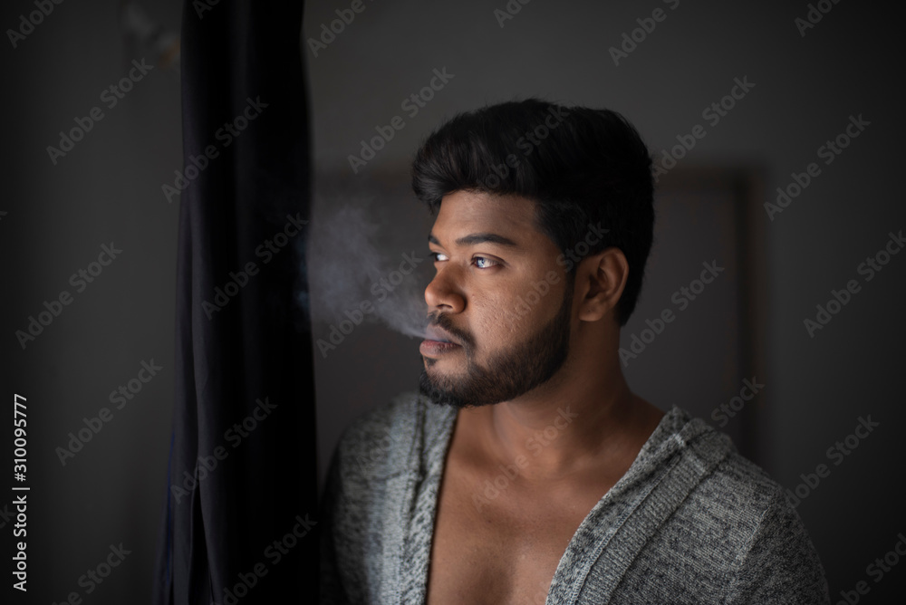 An young tall, dark and handsome Indian Bengali man in a front open ...