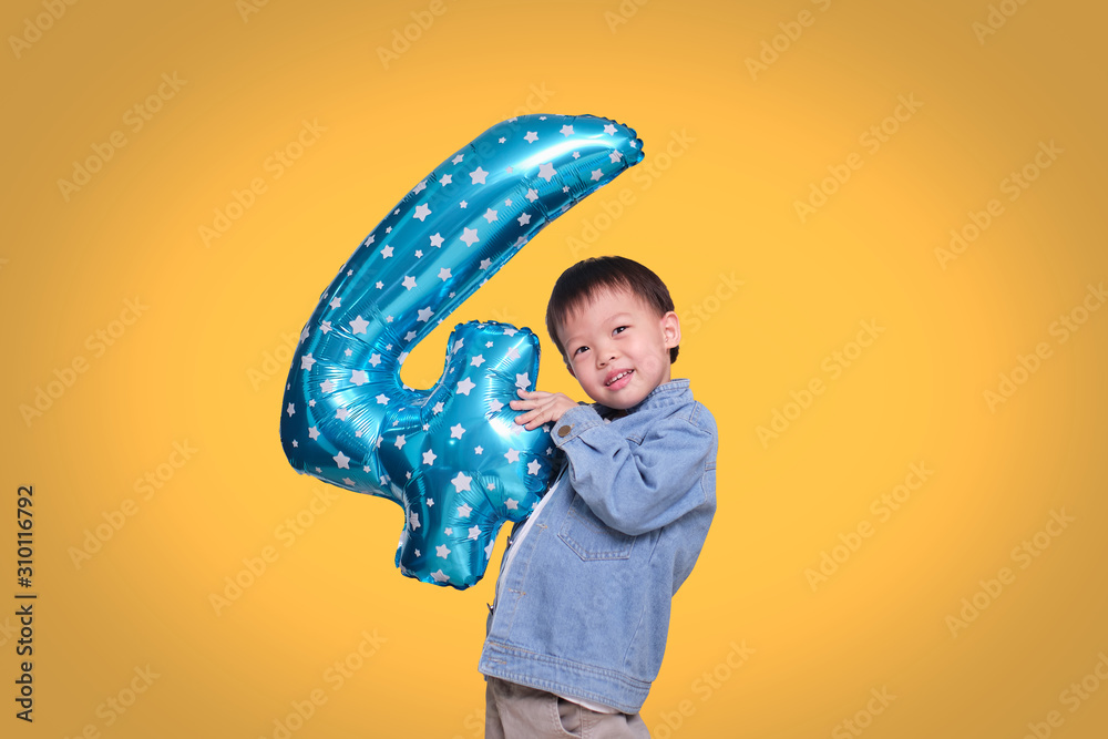 Adorable Asian four year old boy celebrating his birthday holding ...