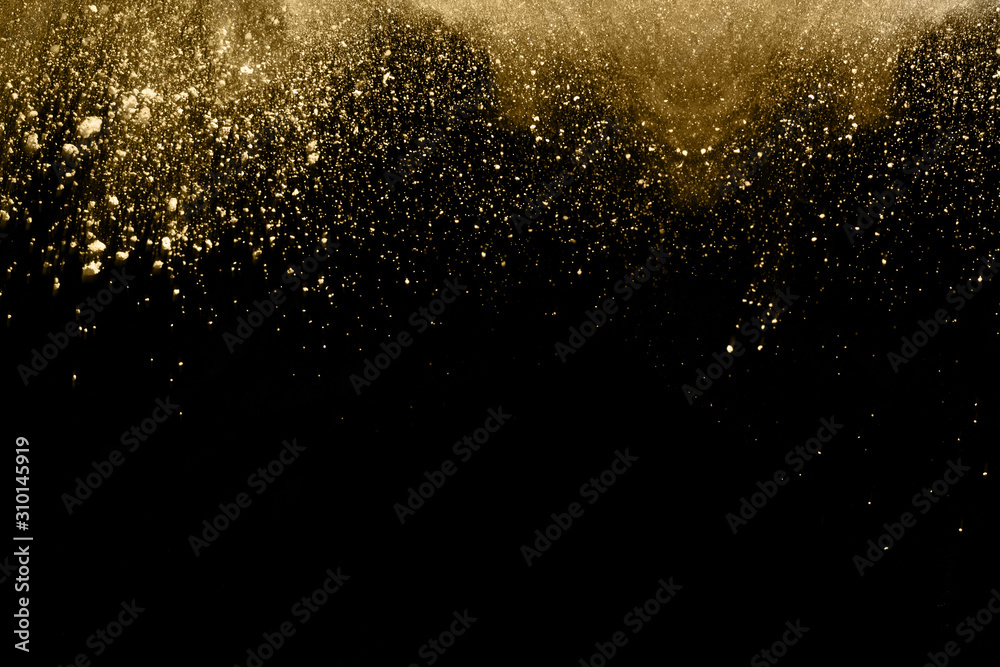 Golden powder explosion on black background. Stock Photo | Adobe Stock