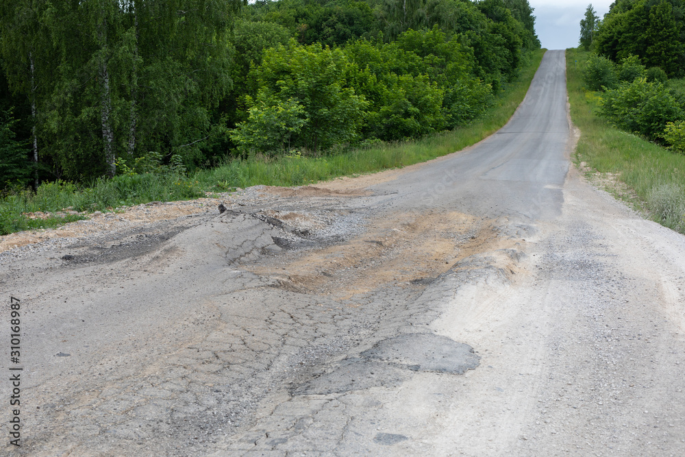 Damaged road, cracked roadway. Track with broken asphalt. Stock Photo ...