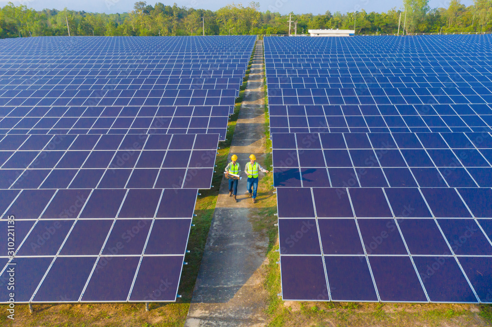 Aerial view of engineer or worker, people, with solar panels or solar ...