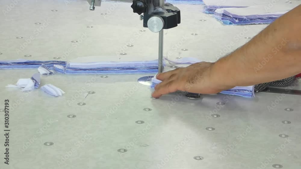 tailor with electric knife cut outs parts for sewing. industrial ...