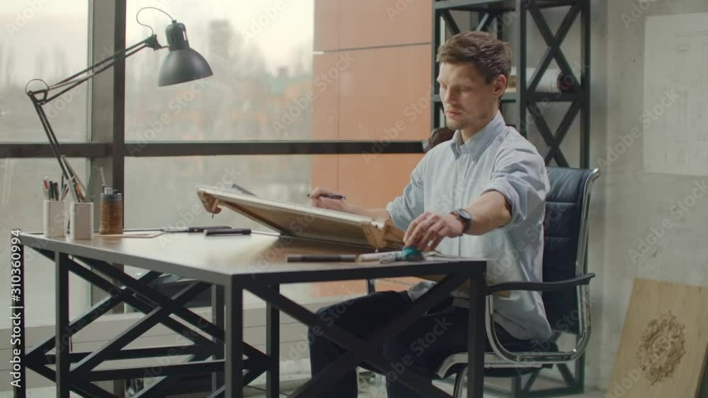 architect man Standing working with blueprints sketching a construction ...