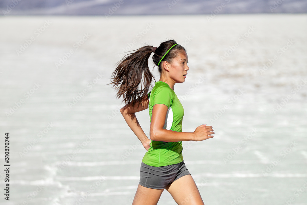 Runner athlete woman running trail run race in desert background. Long ...